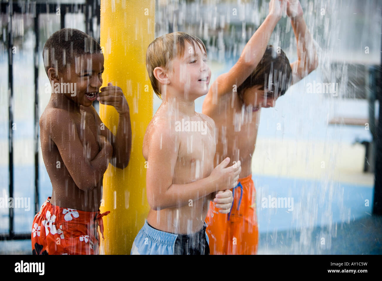 Boys standing together under a shower Stock Photo - Alamy