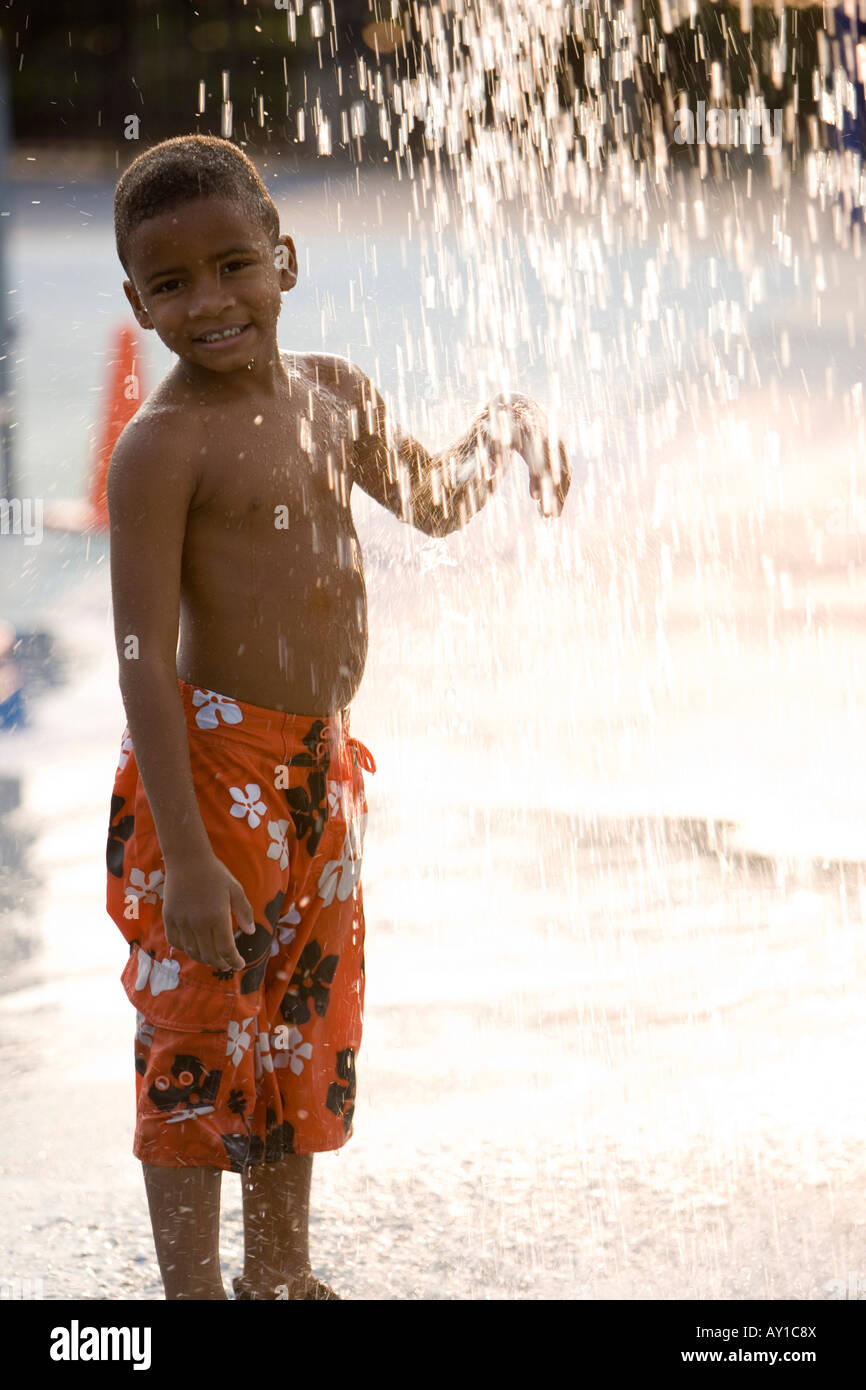Portrait of a boy standing under a shower Stock Photo - Alamy