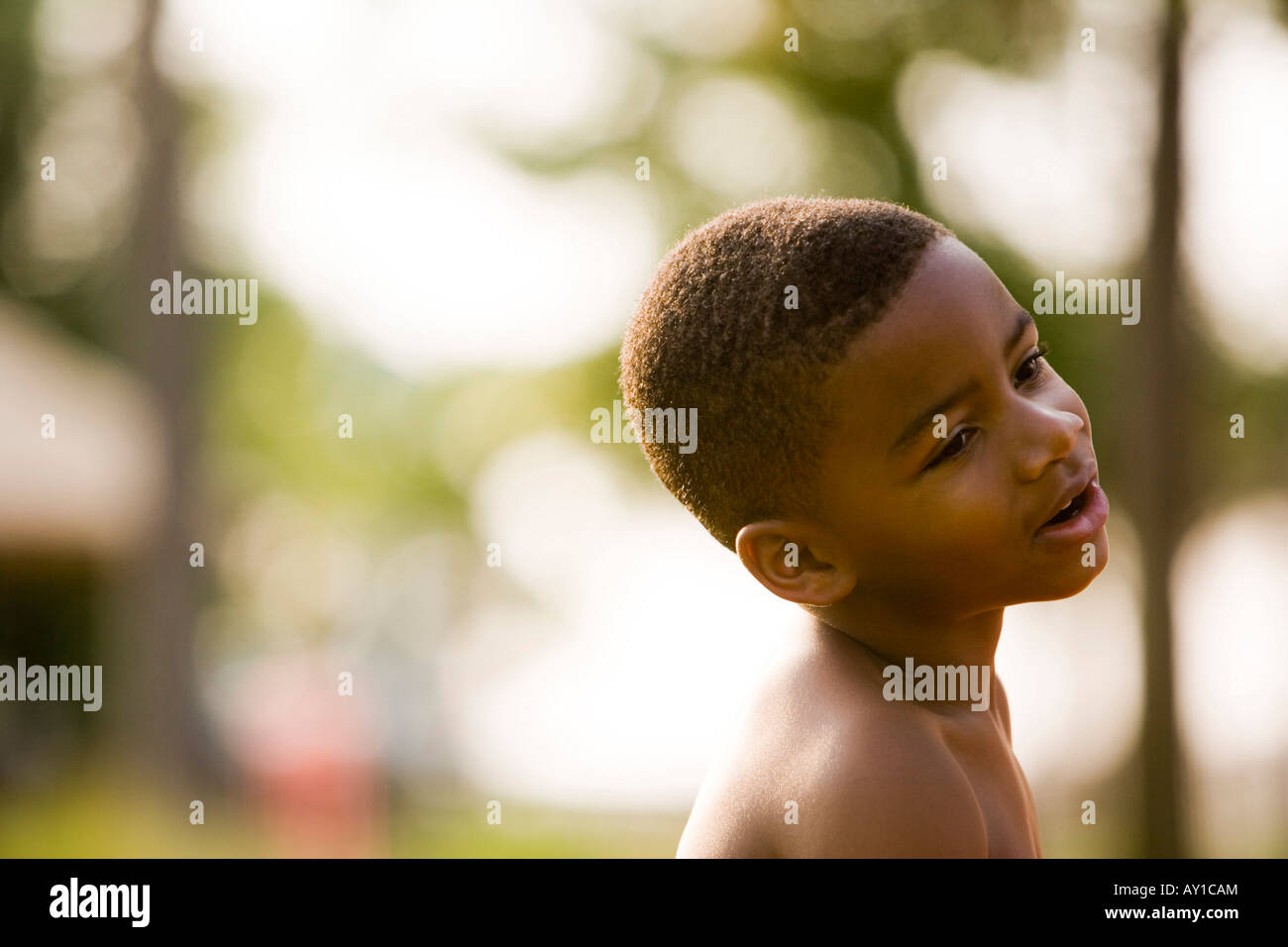 Side view of a shirtless boy looking away Stock Photo - Alamy