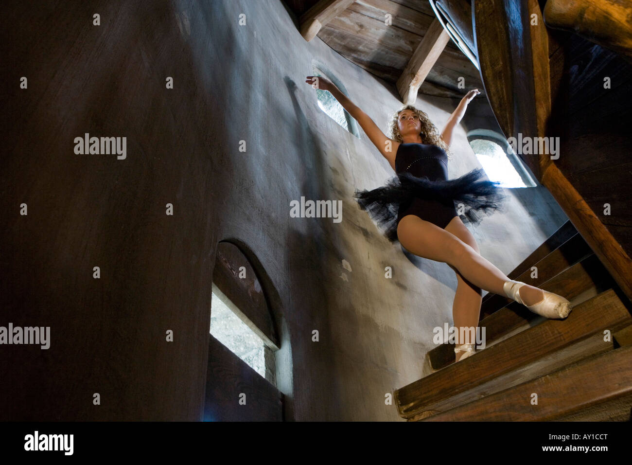 Young woman wearing a tutu and dancing on wooden staircase Stock Photo ...