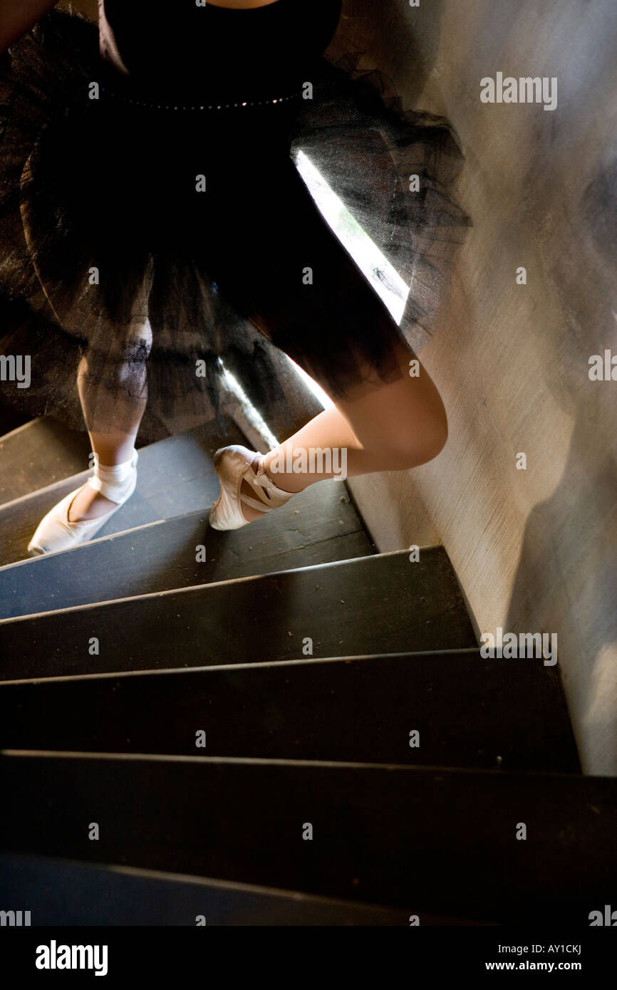 Low section of a ballet dancer climbing up wooden steps Stock Photo - Alamy