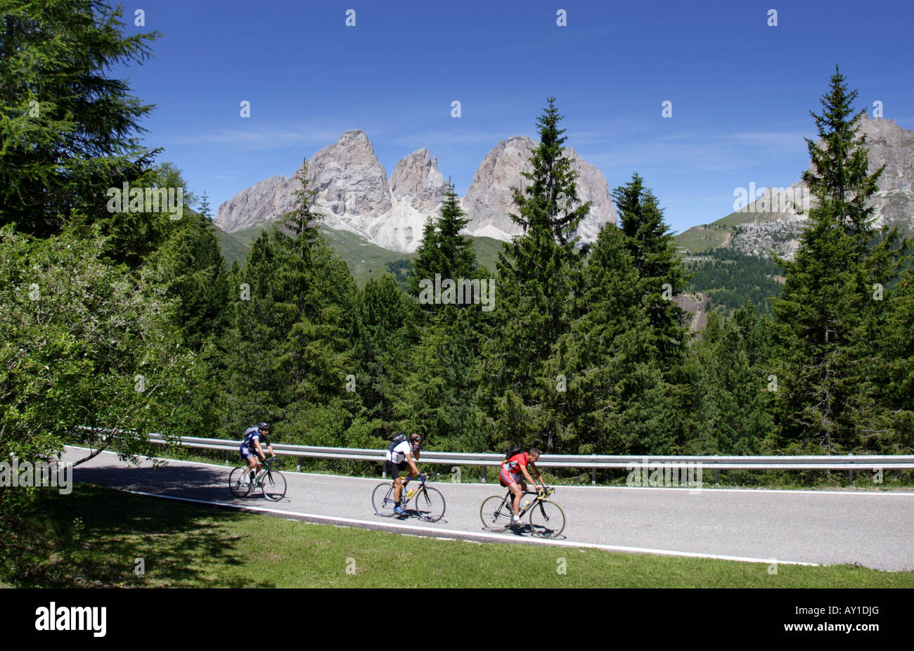 Cyclists on Sella Pass, with peaks of Sassolungo in the background ...