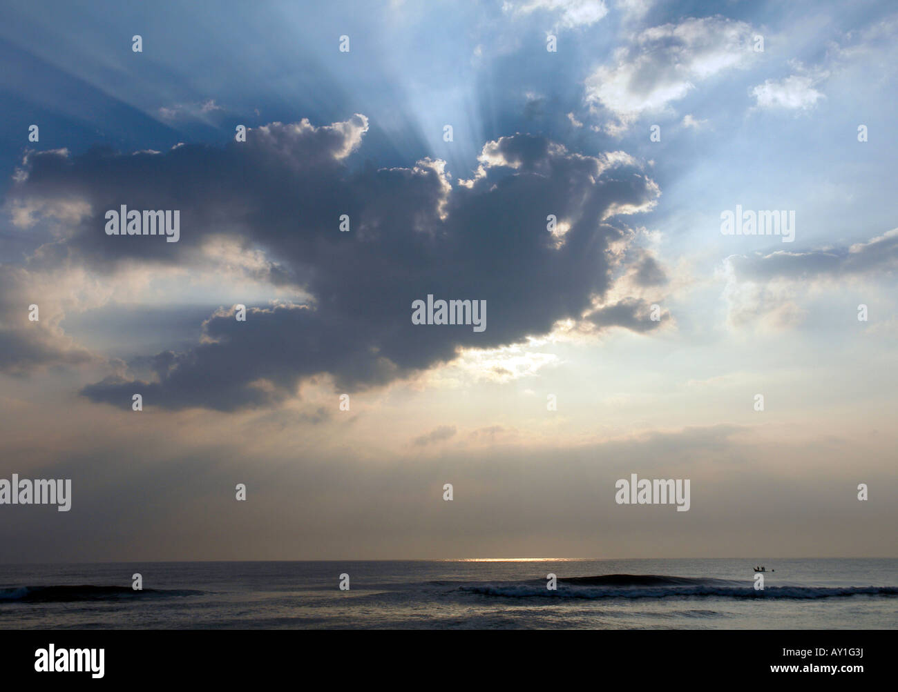 indian cloud and seascape at dawn with fishing boat from the beach at ...