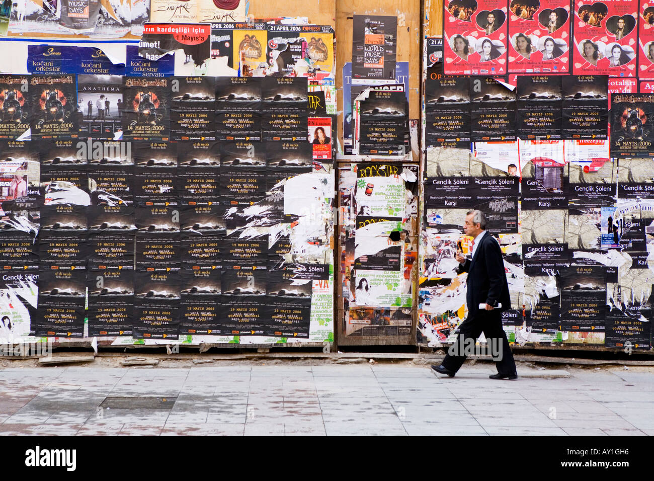 A man walking by a lot of advertising posters in Istanbul, Turkey Stock ...