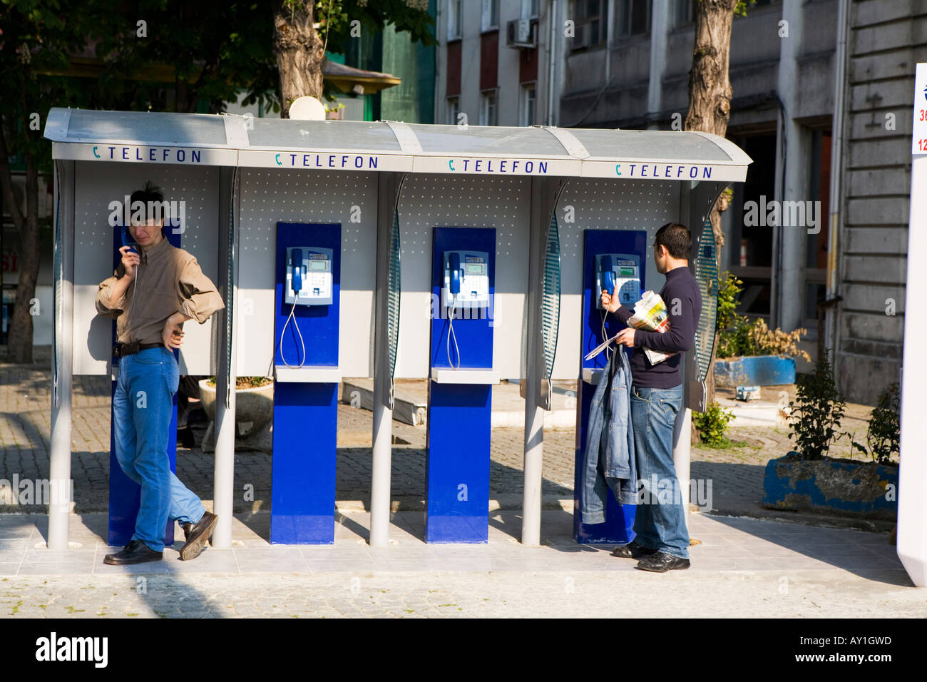 Two people at phone booths in Istanbul, Turkey Stock Photo - Alamy