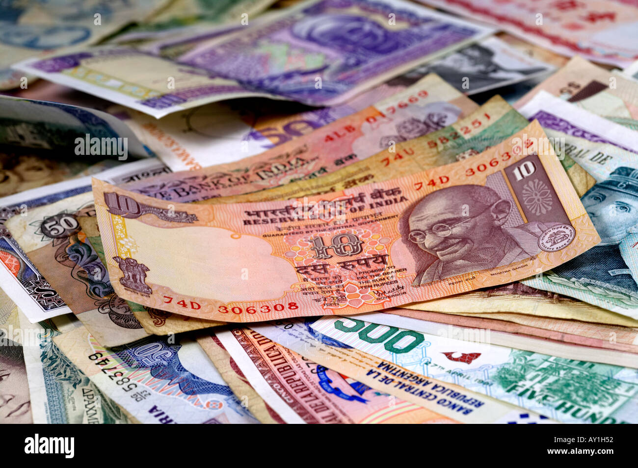India Indian Rupees laying on top of international currency banknotes ...