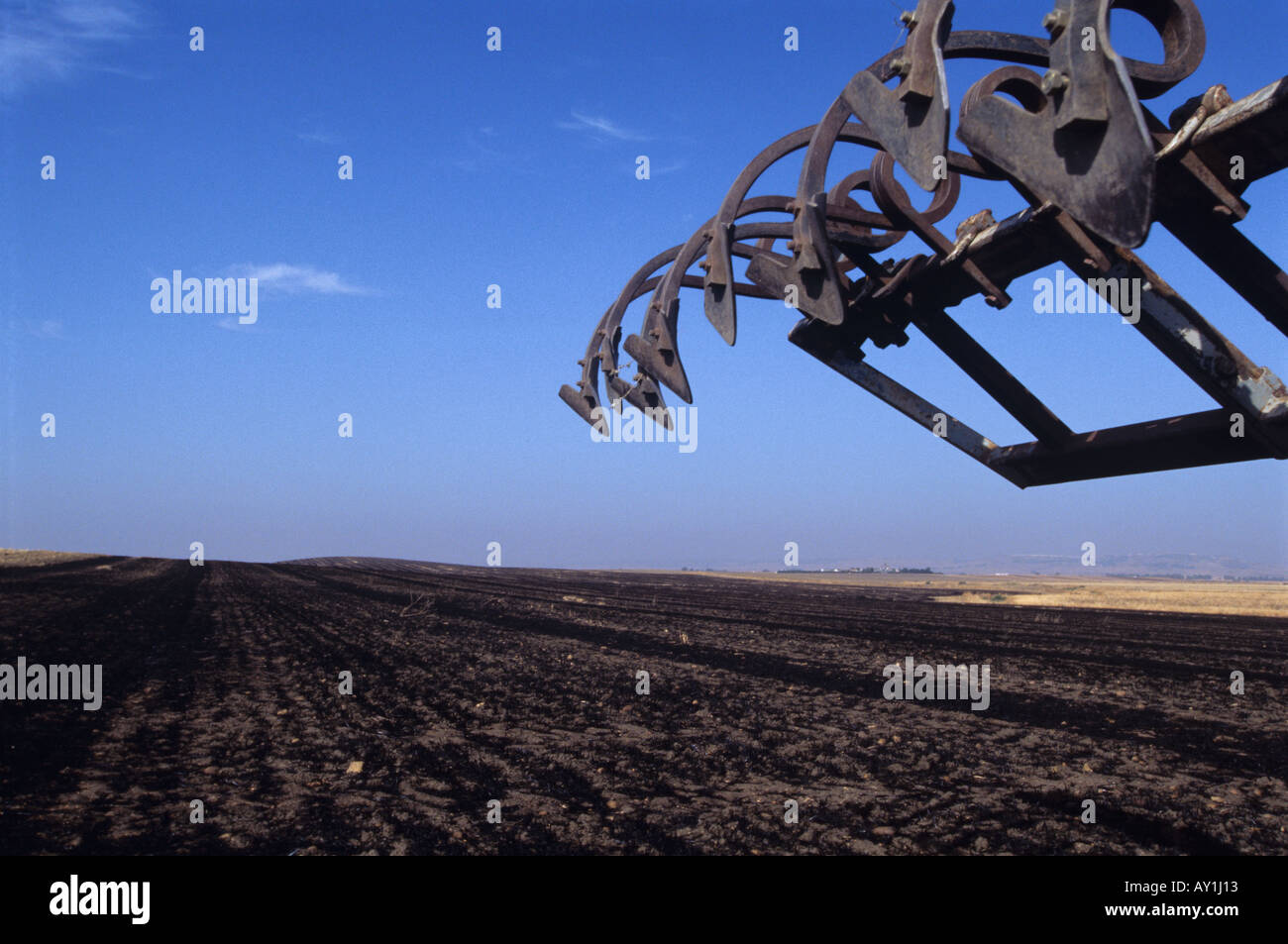A harrow a sort of shallow plough mounted on the back of a tractor rear ...