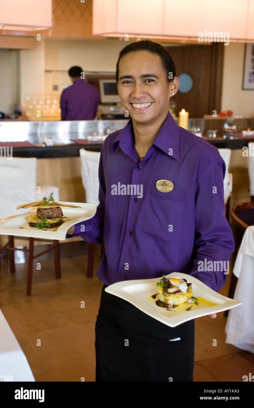 Waiter holding food plate at Medzo restaurant in the Pyramids complex ...