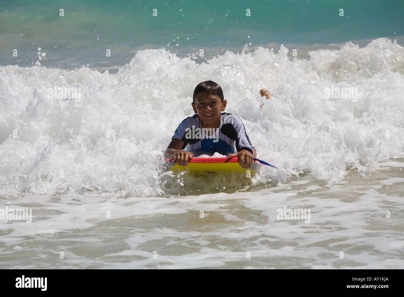 Boy riding a body board at Kailua beach, Oahu, Hawaii Stock Photo - Alamy