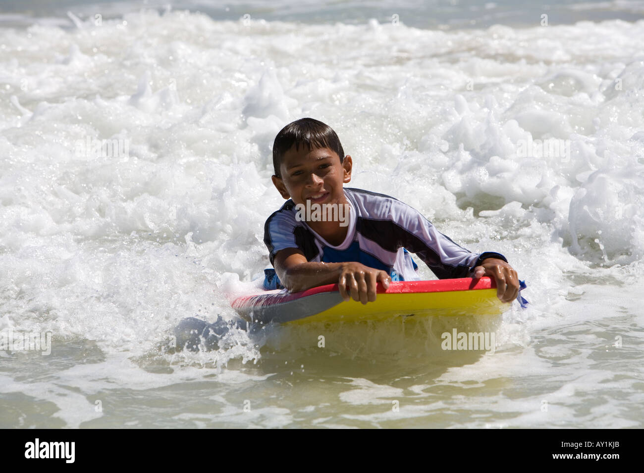 Boy riding a body board at Kailua beach, Oahu, Hawaii Stock Photo - Alamy