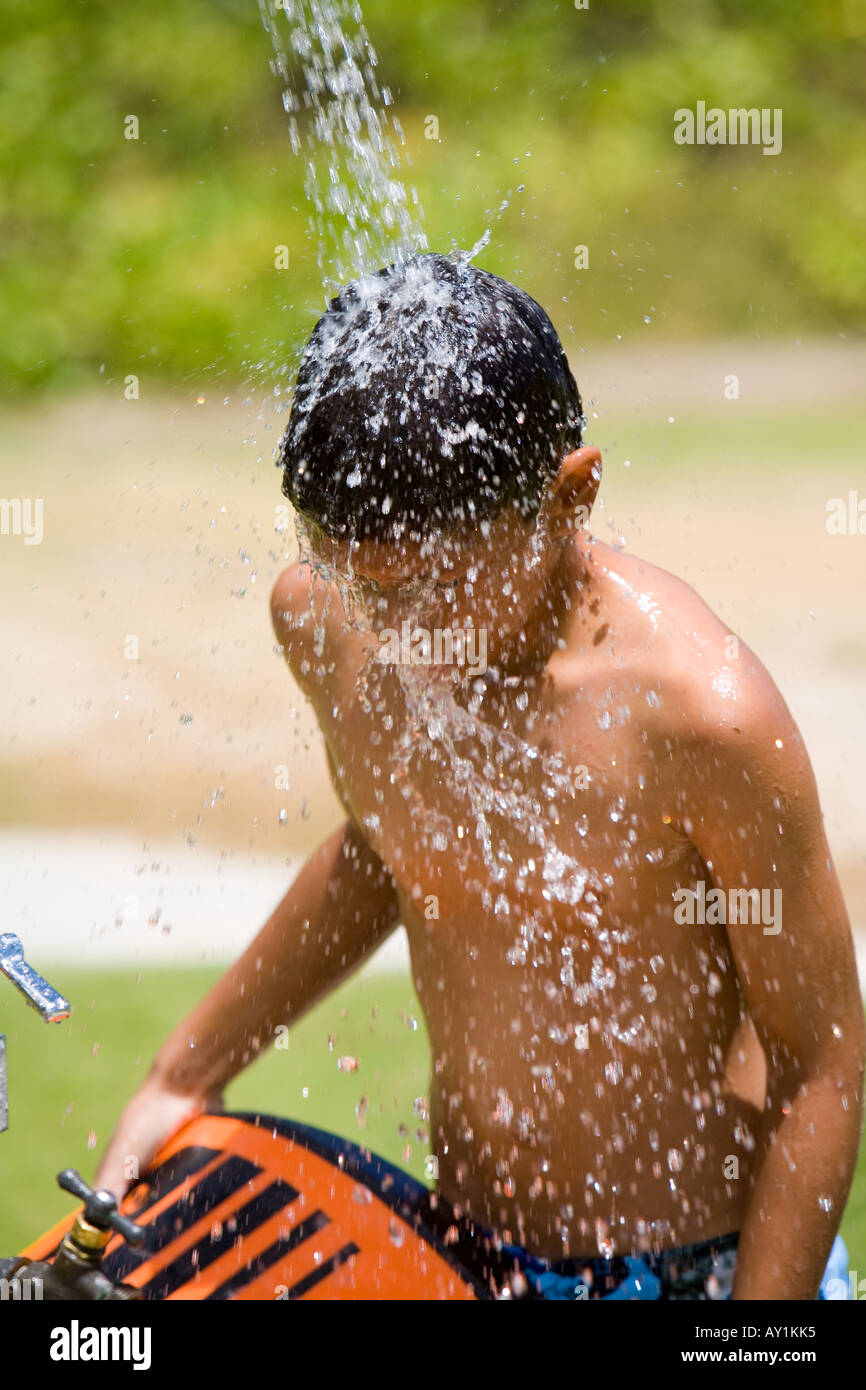 Boy taking a shower at Kailua beach in Hawaii Stock Photo - Alamy