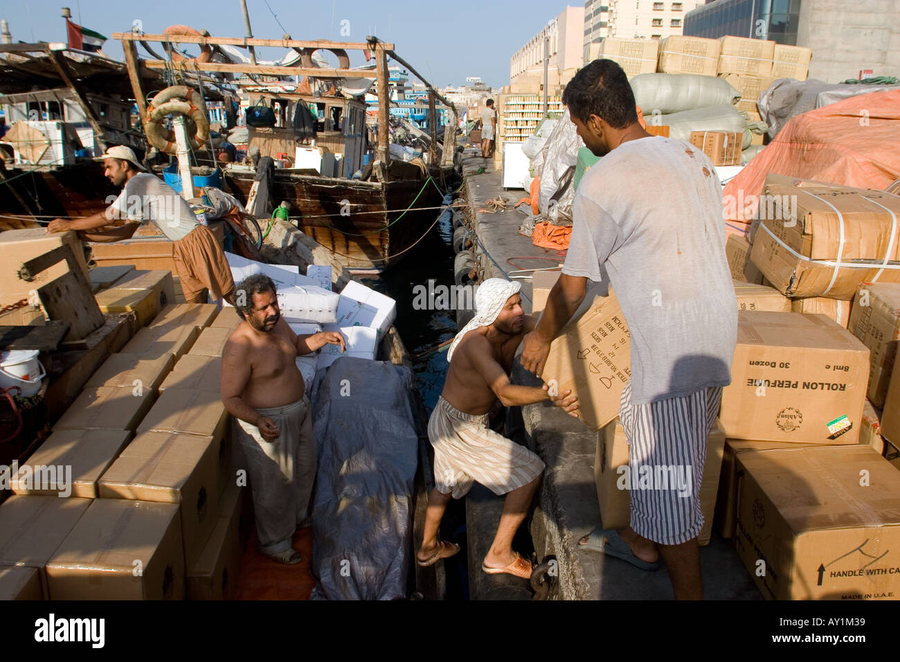 Workers loading cargo on Dhow Cargo boats docking at Dubai Creek Dubai ...