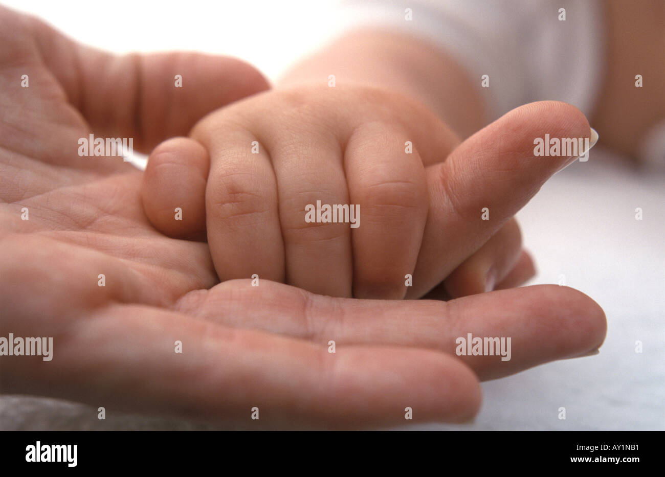 Baby hand holding mothers finger Stock Photo - Alamy