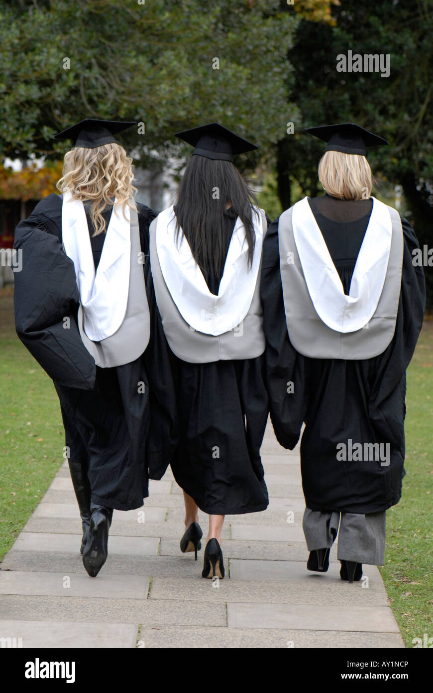 Graduate dressed in gown and mortar board on the way to graduation ...