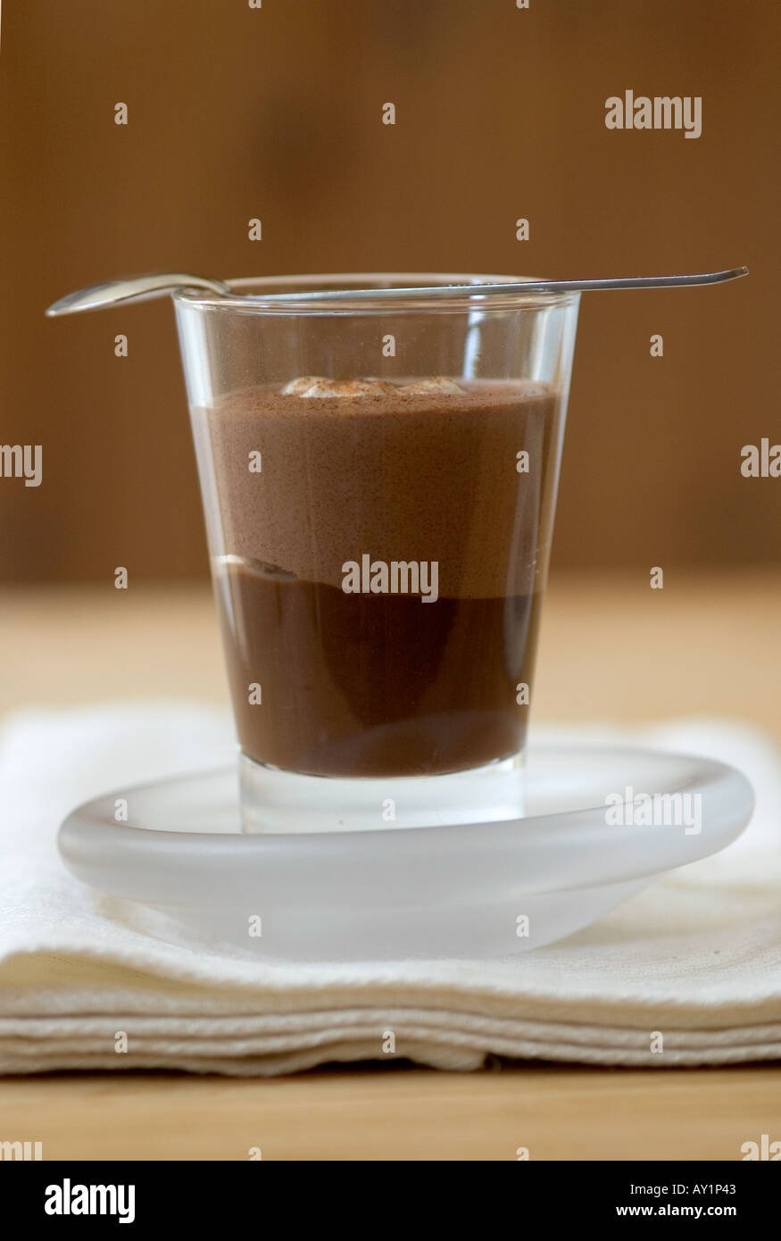 Chocolate mousse dessert being eaten in clear glass with spoon Stock ...