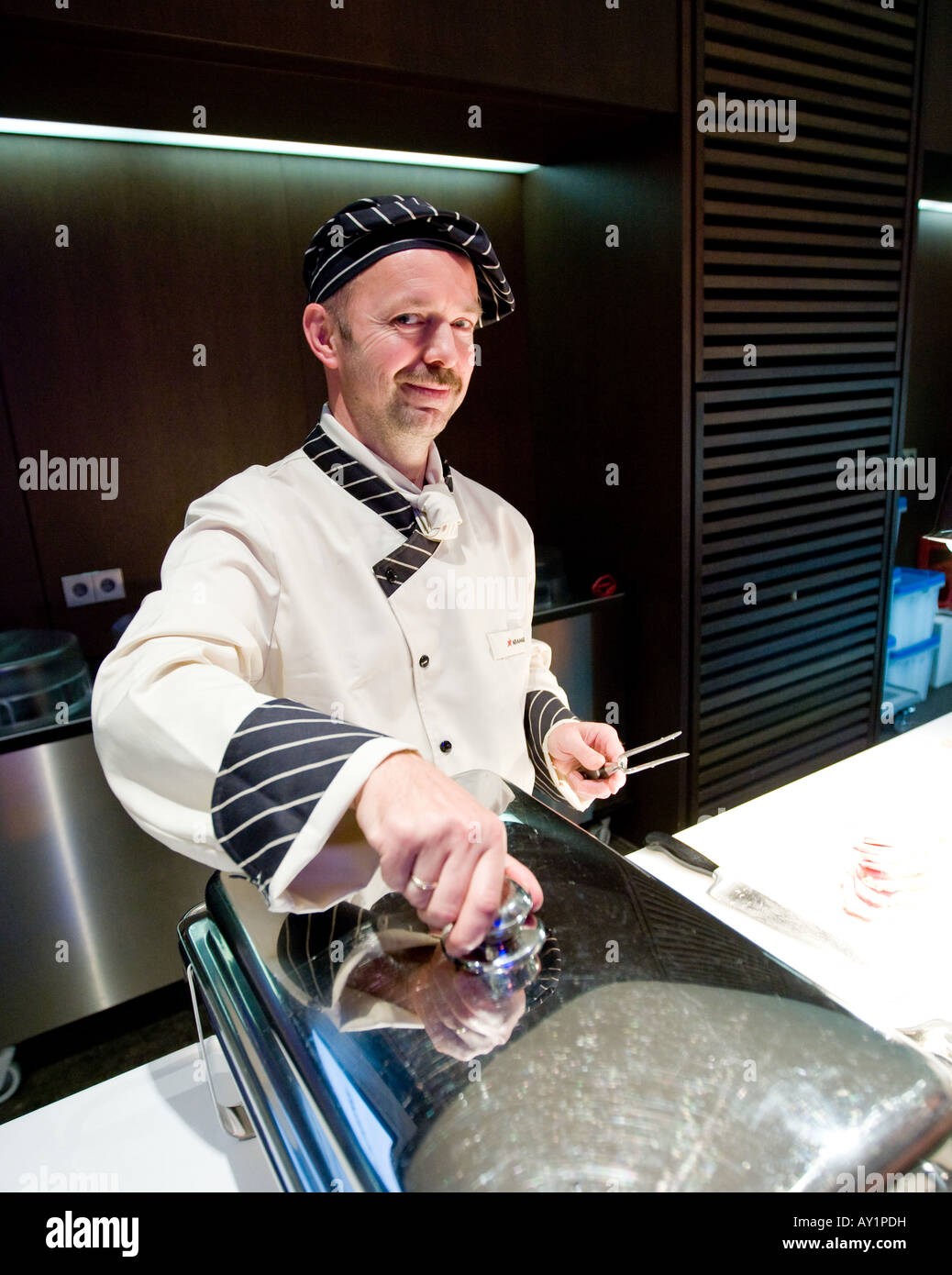waiter picking up serving dish in restaurant Stock Photo - Alamy