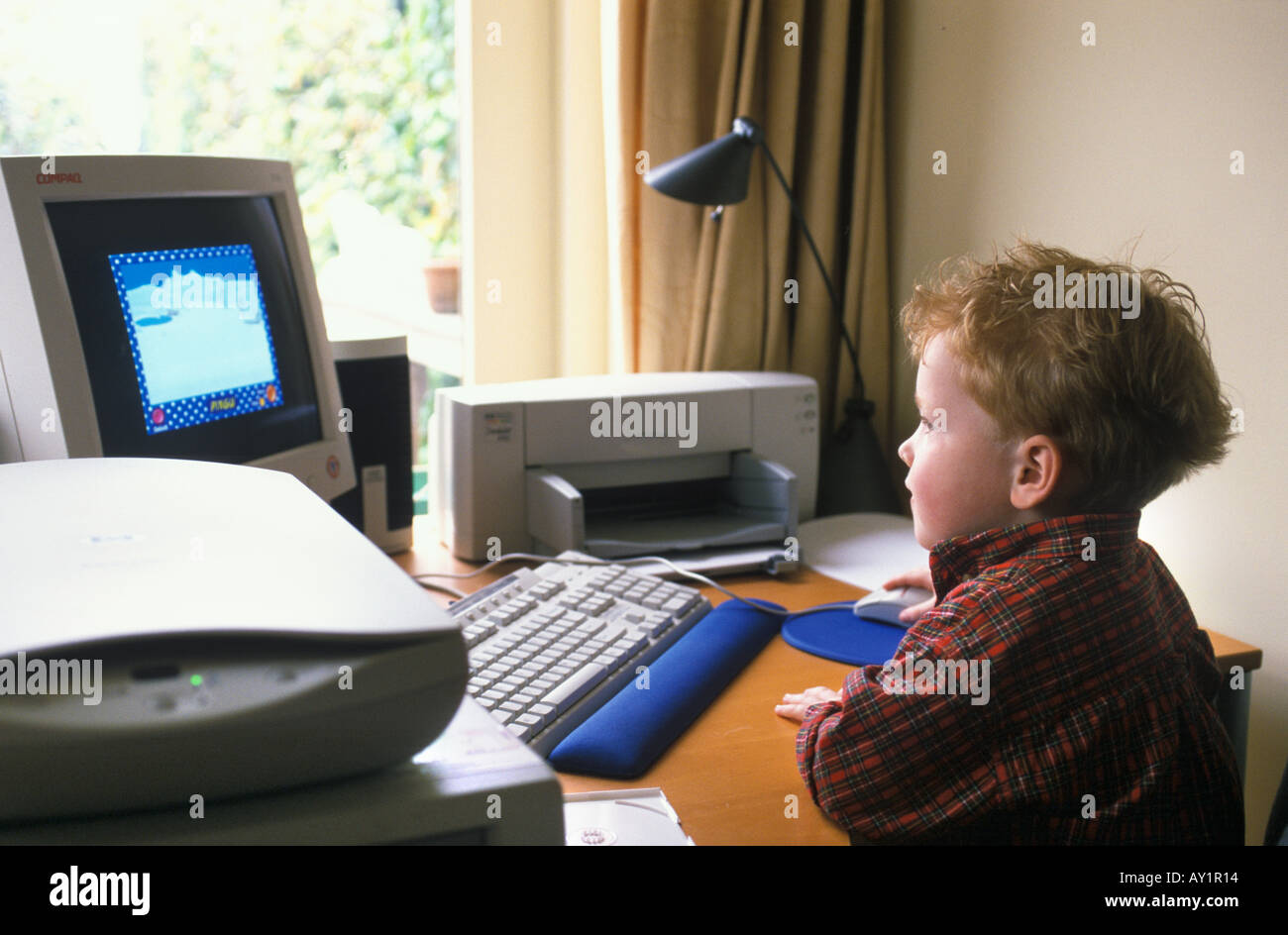 Boy behind his computer in his room Stock Photo - Alamy