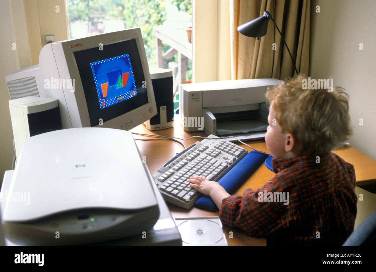 Boy behind his computer in his room Stock Photo - Alamy