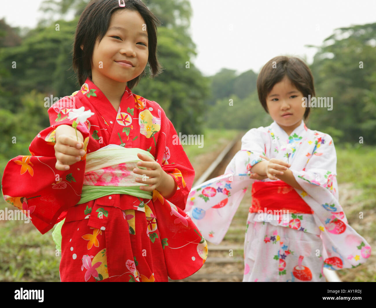 Two children offering flowers hi-res stock photography and images - Alamy