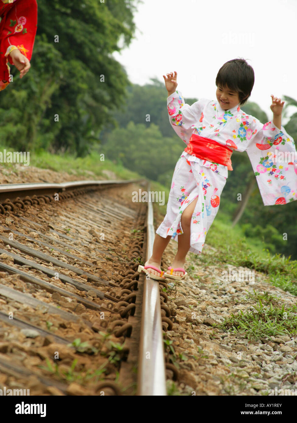 Two girls walking on railroad tracks Stock Photo - Alamy