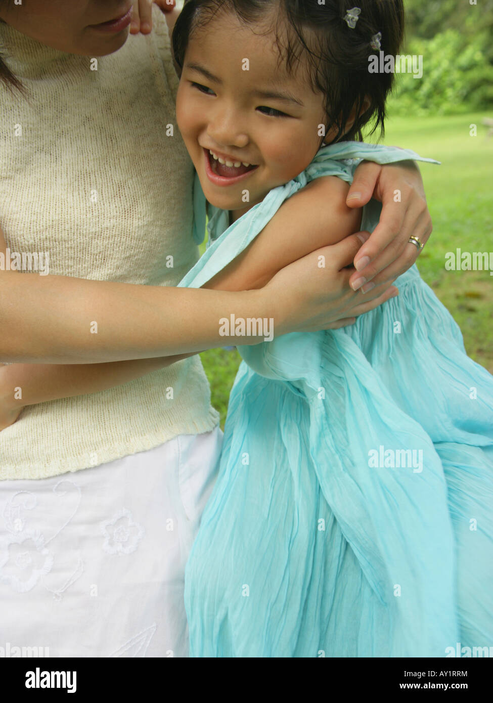 Mother hugging her daughter Stock Photo - Alamy