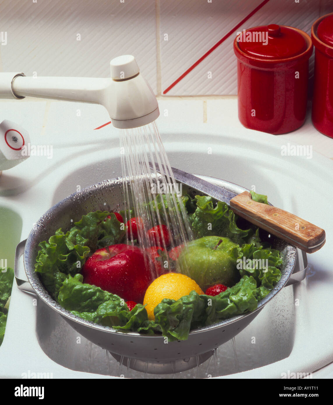 Fresh Fruit being washed in sink Stock Photo - Alamy