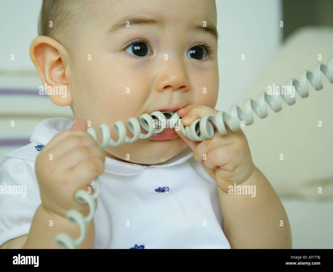 Cute baby biting clothing infant hi-res stock photography and images ...
