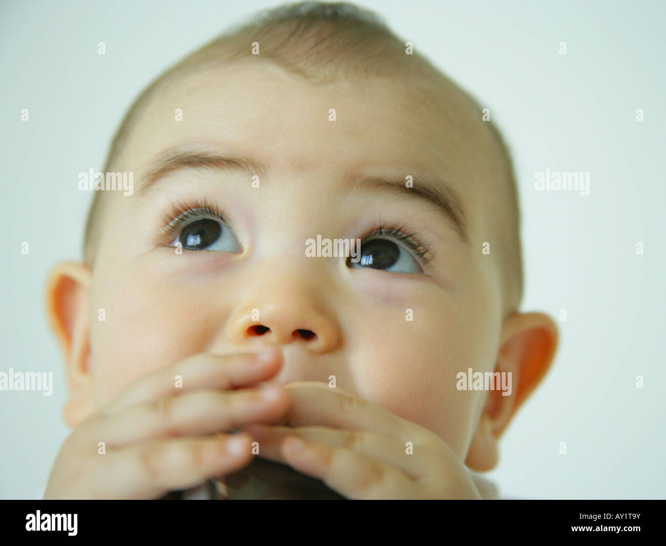 Close-up of a baby girl biting a mobile phone Stock Photo - Alamy