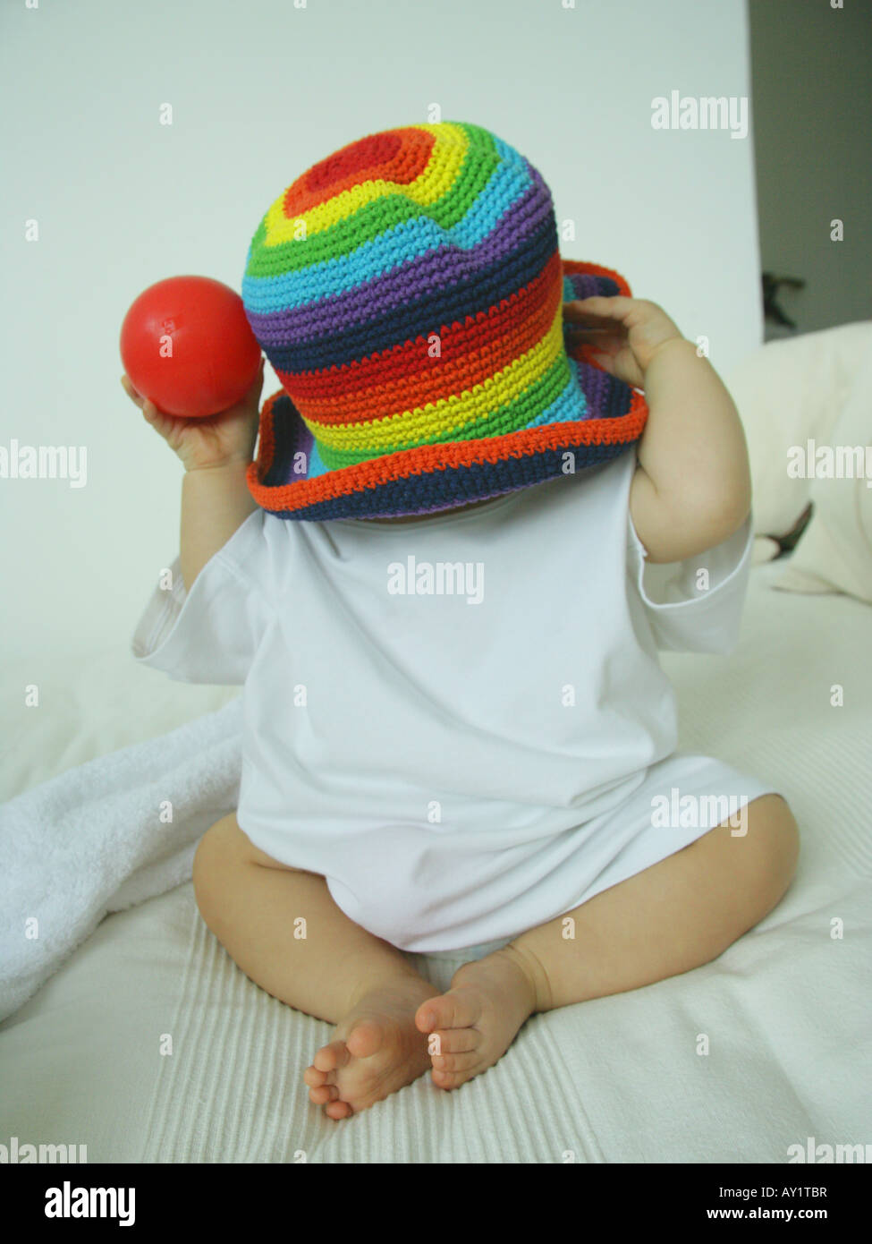 Baby girl covering face with hat hi-res stock photography and images ...