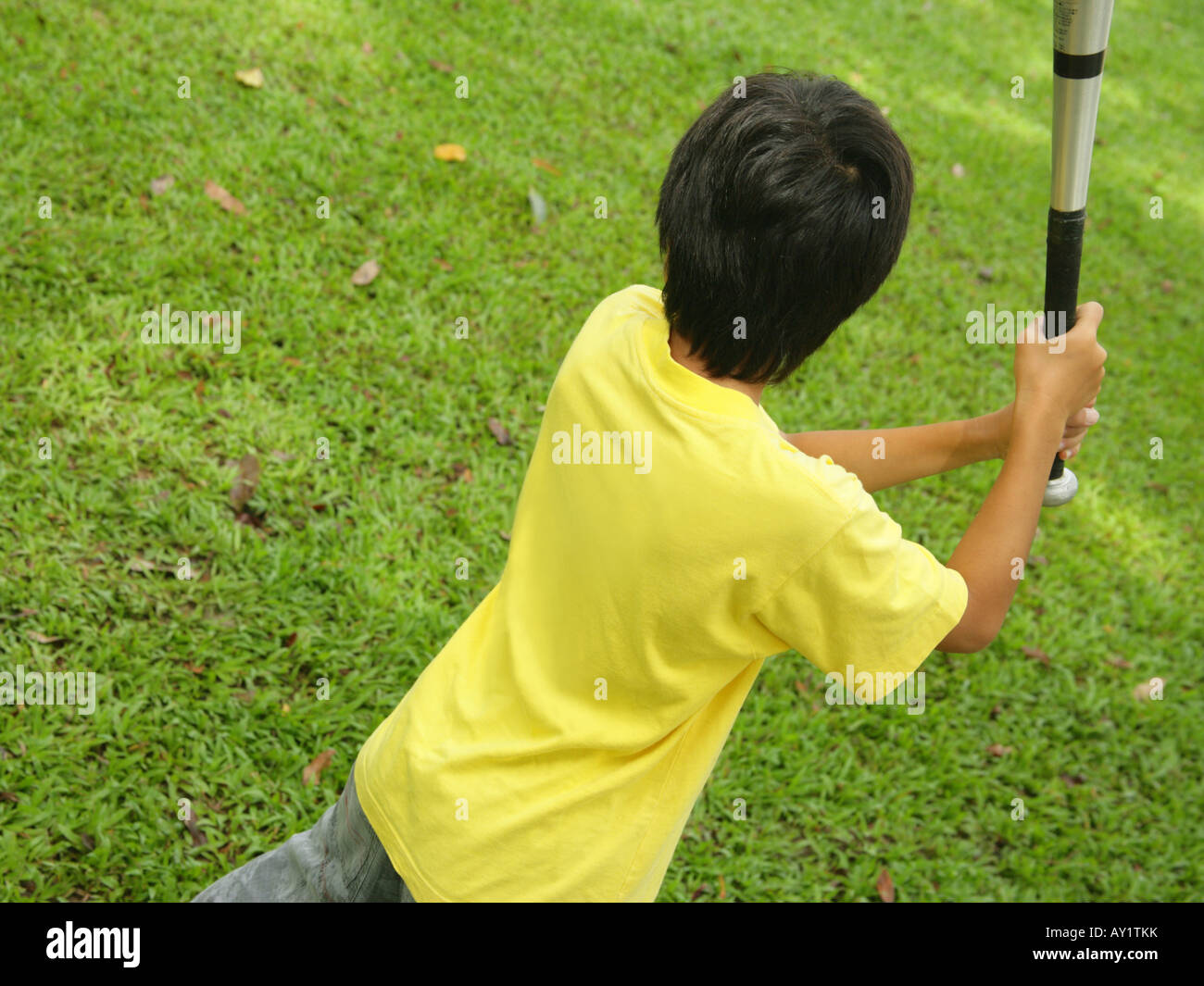Close-up of a boy holding a baseball bat Stock Photo - Alamy