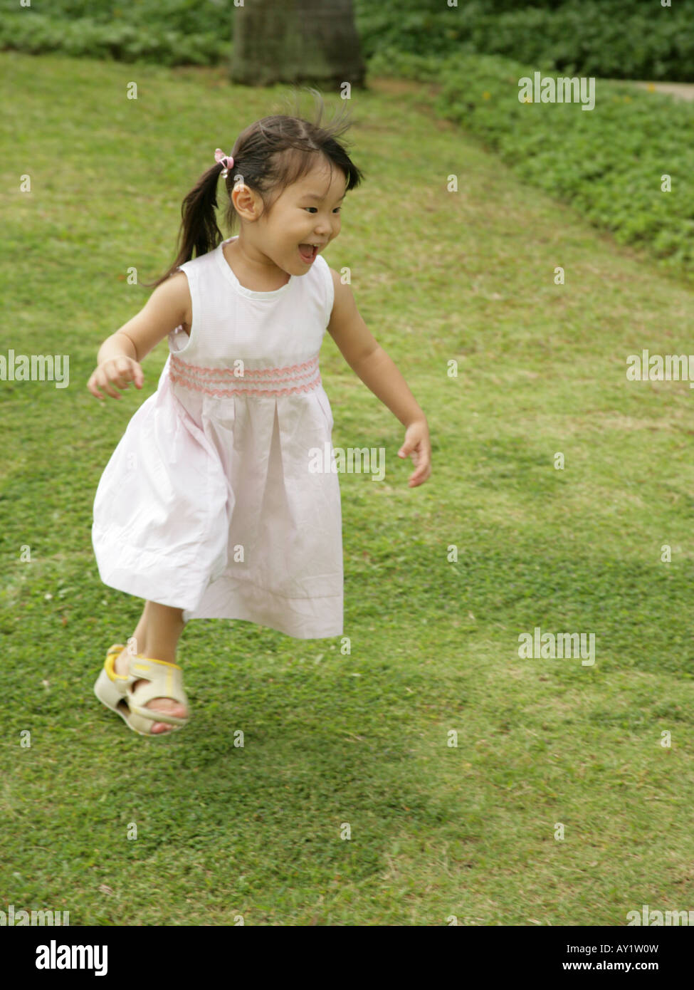 Back view laughing girl running hi-res stock photography and images - Alamy