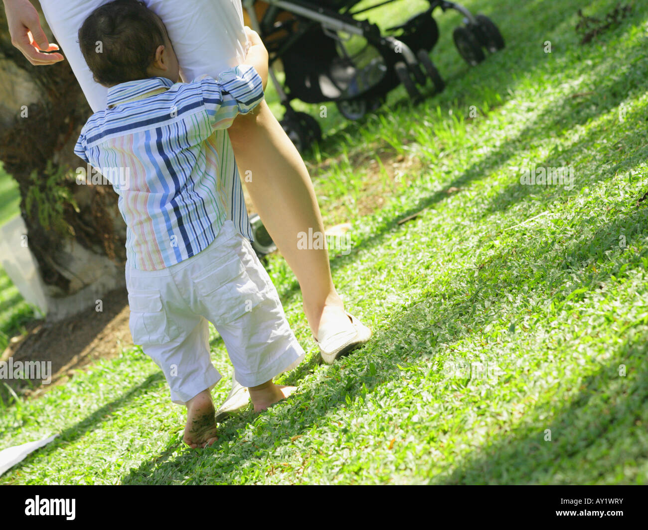 Rear view of a baby boy hugging his mother Stock Photo - Alamy