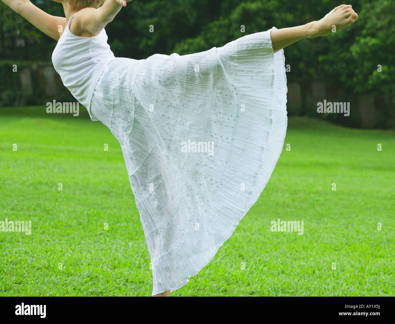 Side profile of a young woman dancing on the lawn Stock Photo - Alamy
