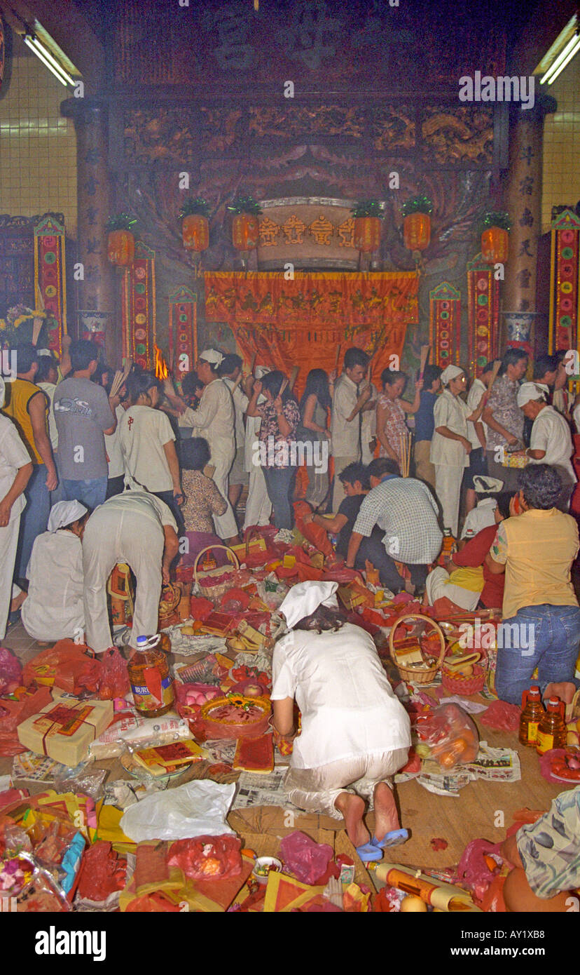 Taoist believers praying inside a Chinese temple in Ampang, Malaysia ...