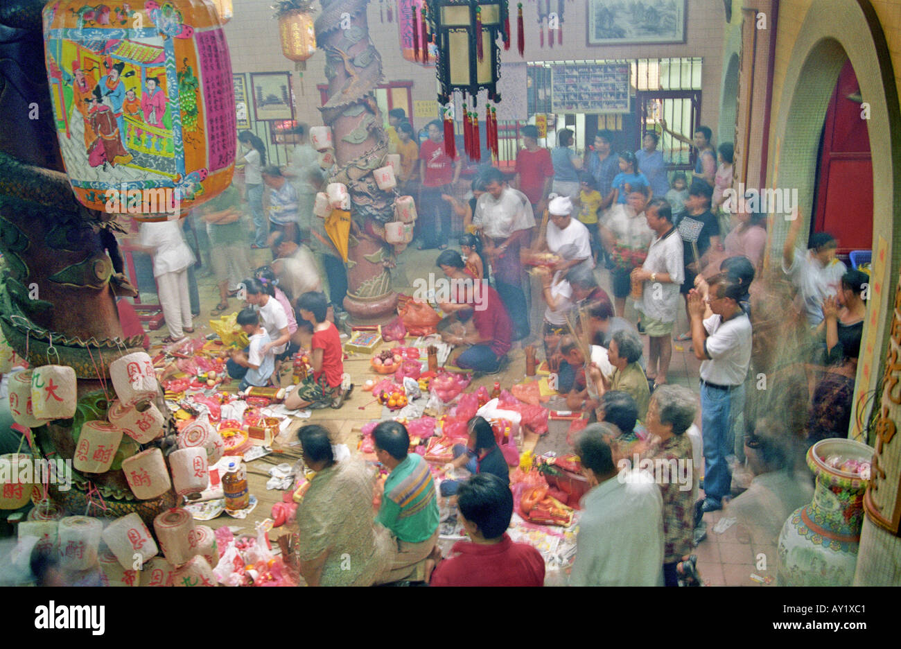 Taoist believers praying inside a Chinese temple in Ampang, Malaysia ...