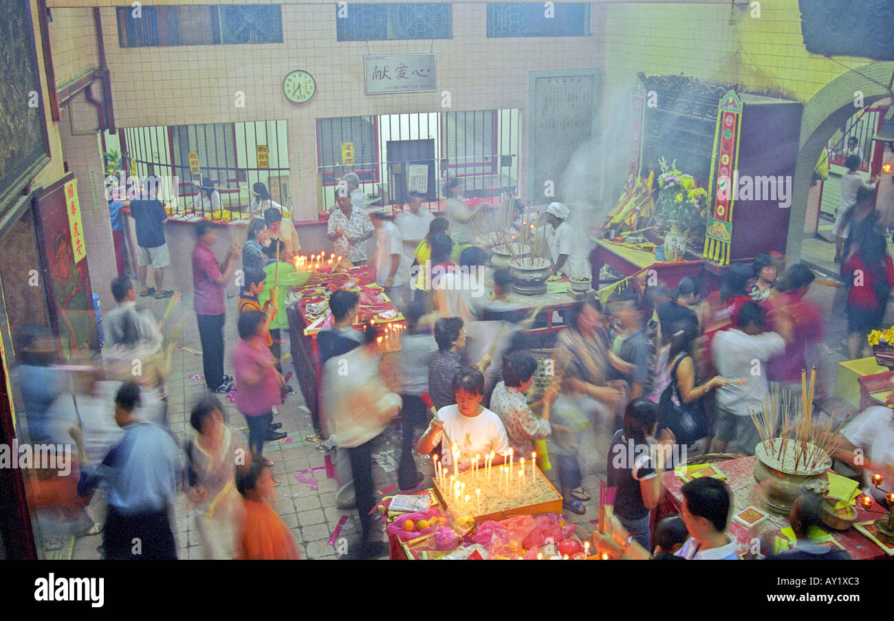 Taoist believers praying inside a Chinese temple in Ampang, Malaysia ...