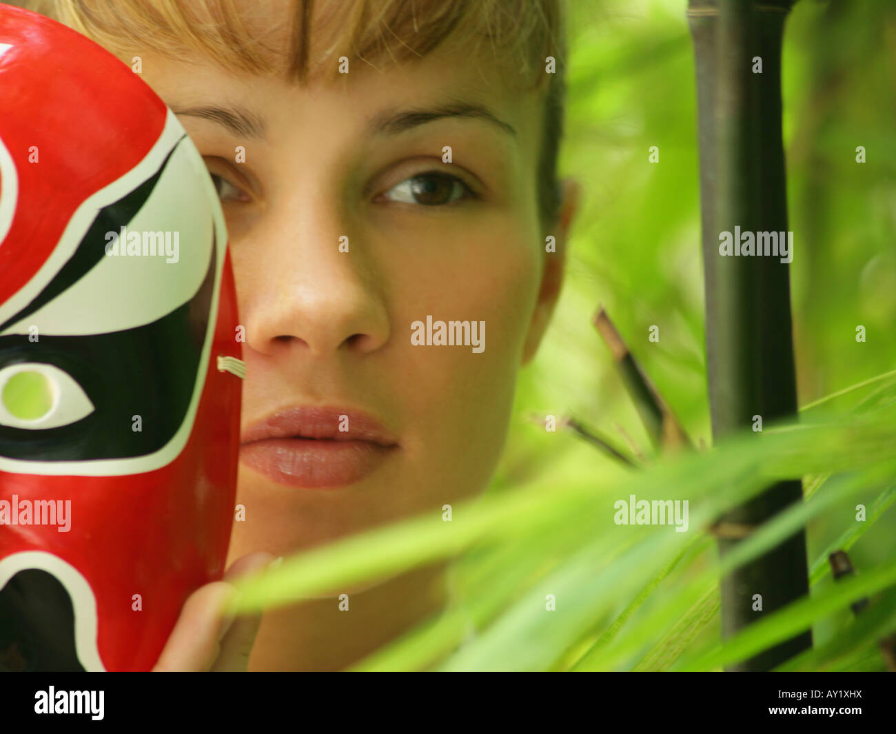 Close-up of a young woman holding a chinese mask Stock Photo - Alamy
