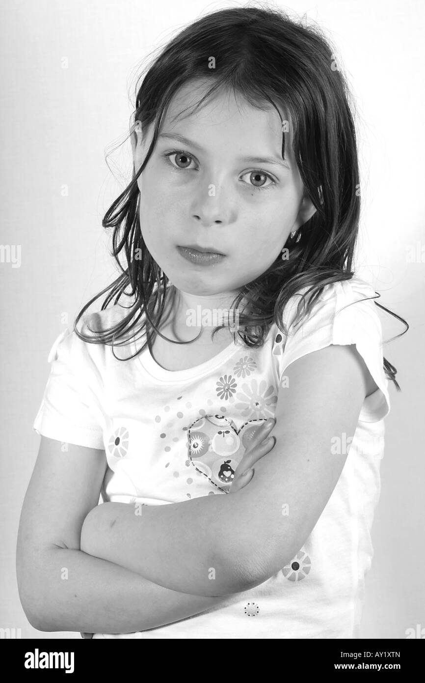 Pretty Young Girl with her arms crossed against a Light Background ...