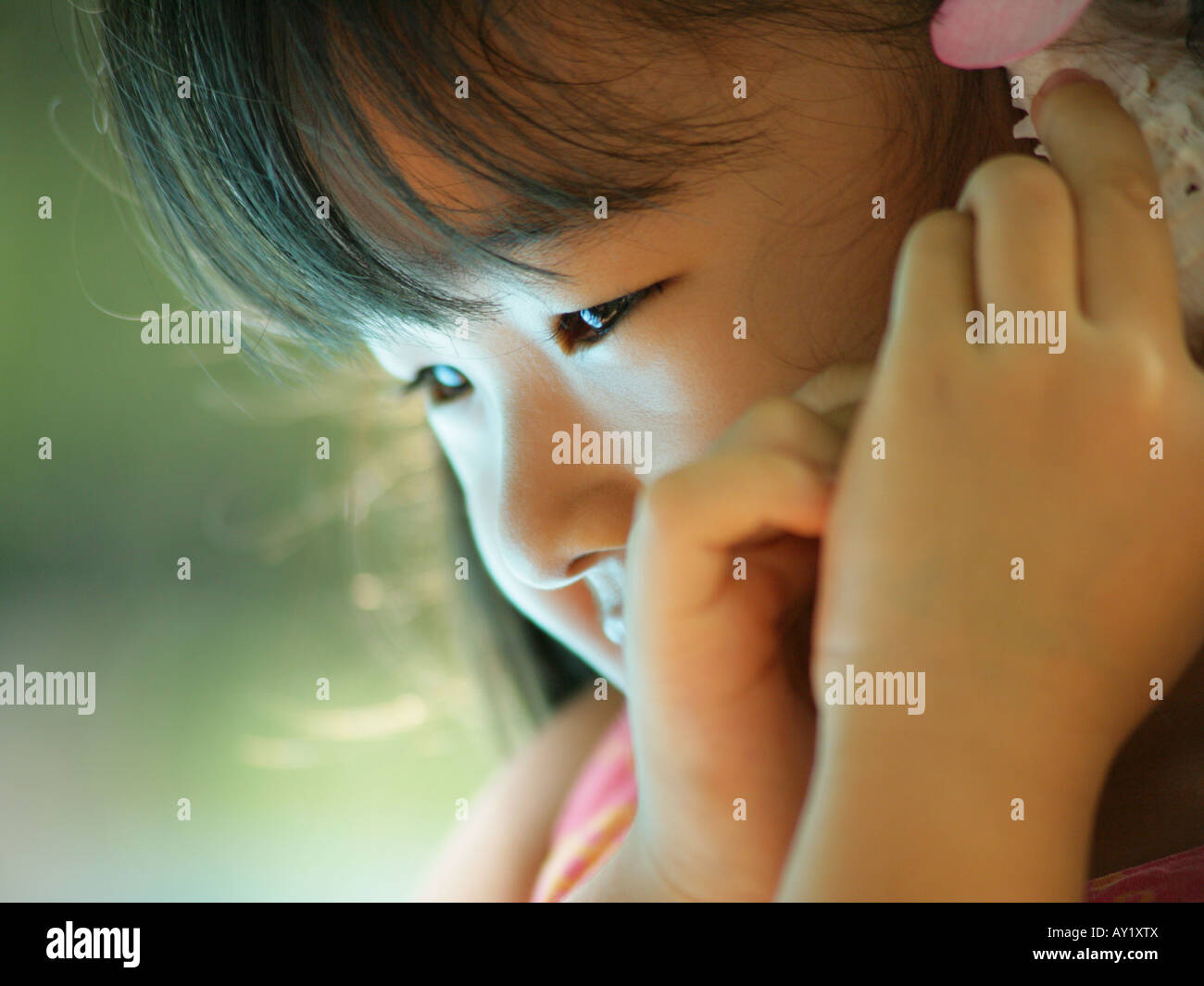 Close-up of a girl holding a conch shell close to her ear Stock Photo ...