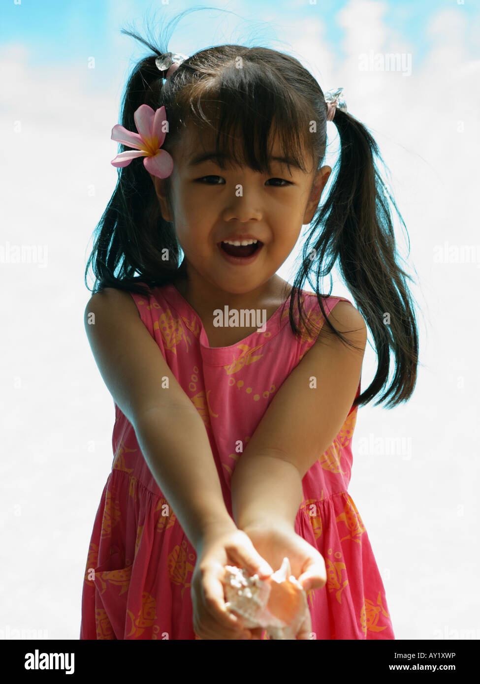 Portrait of a girl holding a conch shell Stock Photo - Alamy
