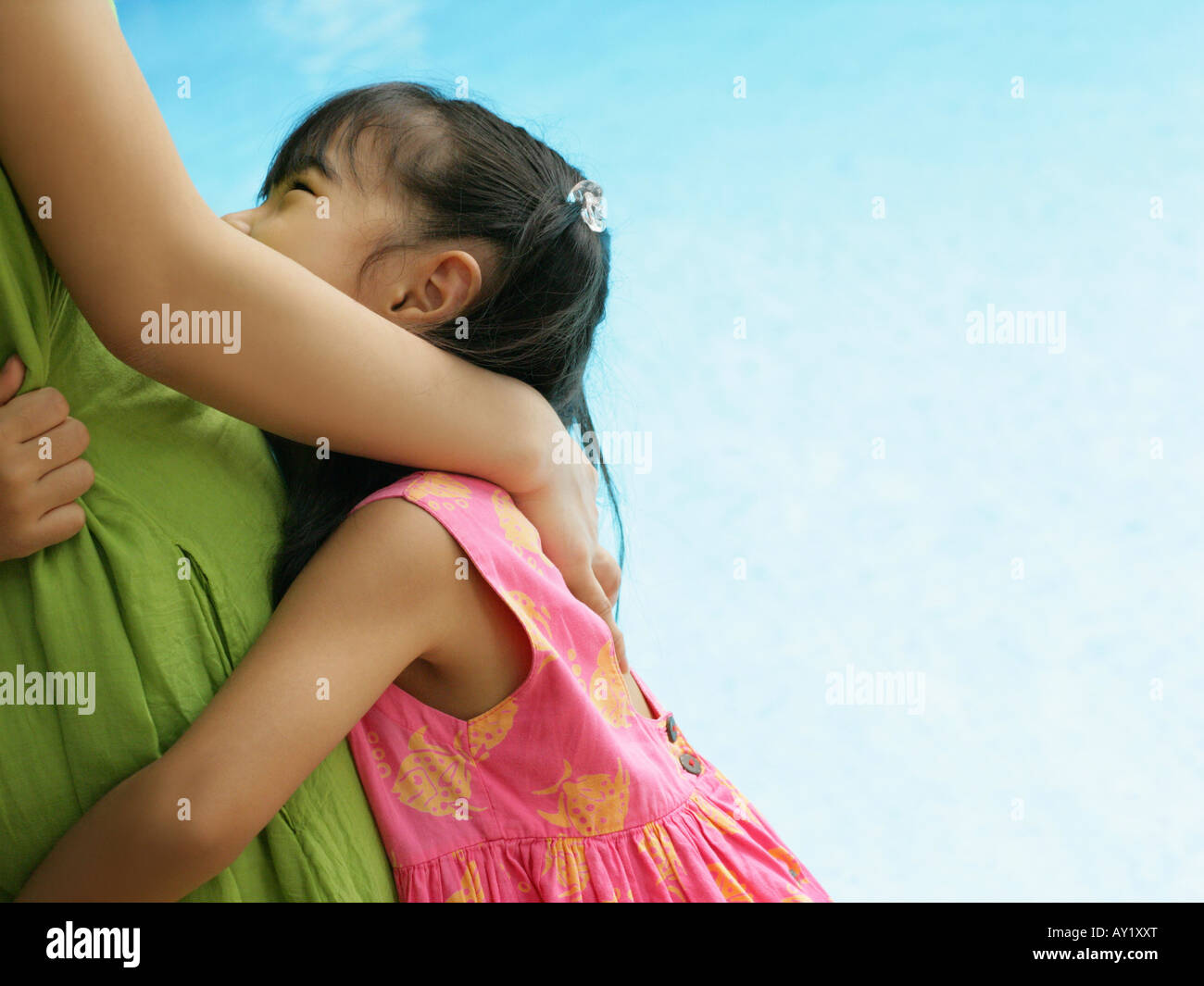 Side profile of a girl hugging her mother Stock Photo - Alamy