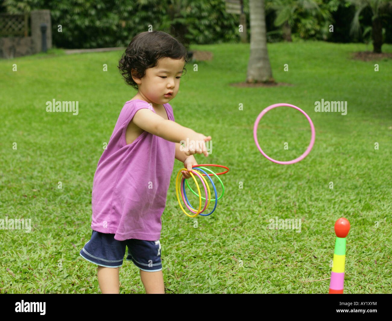 Boy throwing a plastic hoop on a pole Stock Photo - Alamy