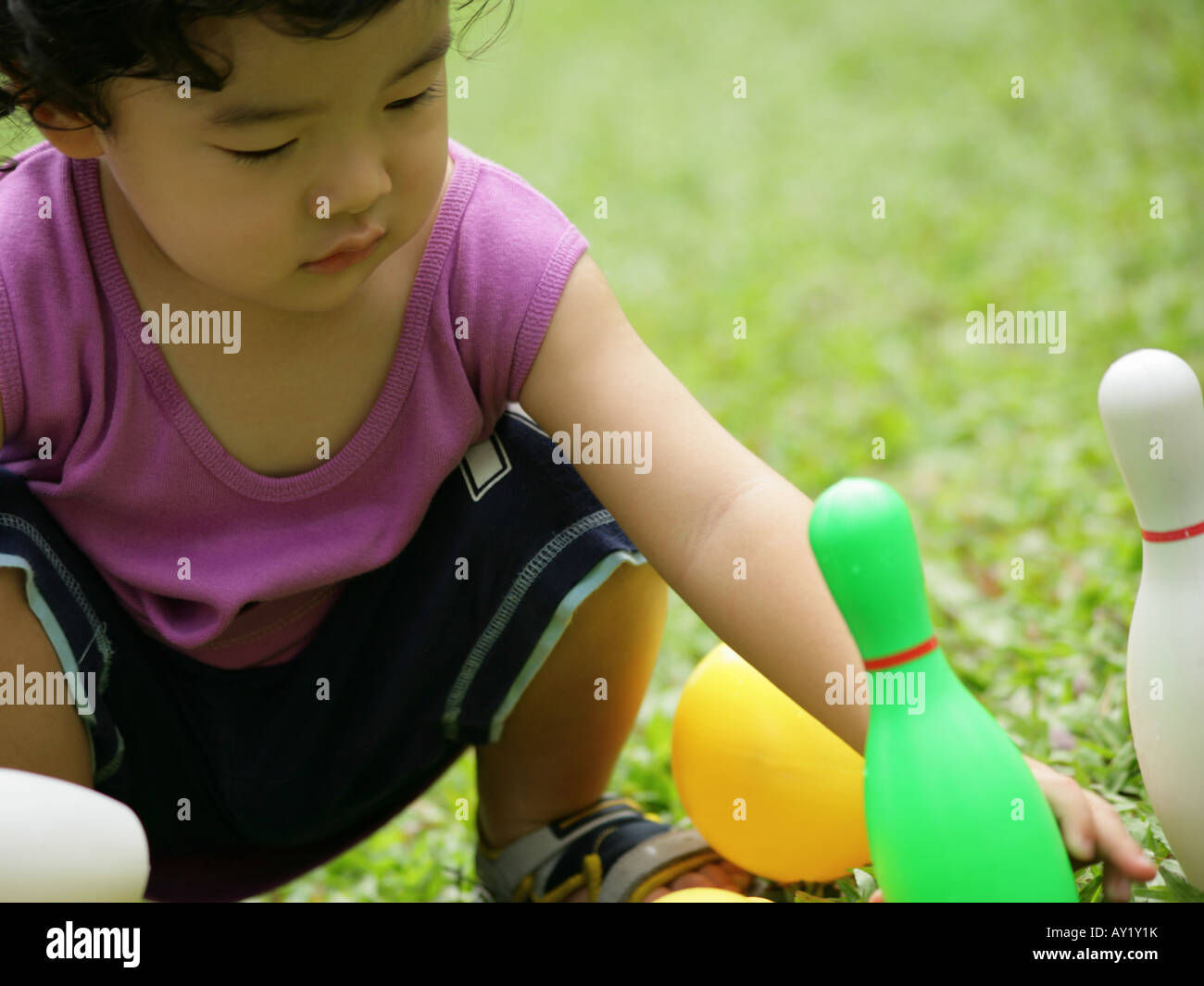 Close-up of a boy playing with bowling pins Stock Photo - Alamy