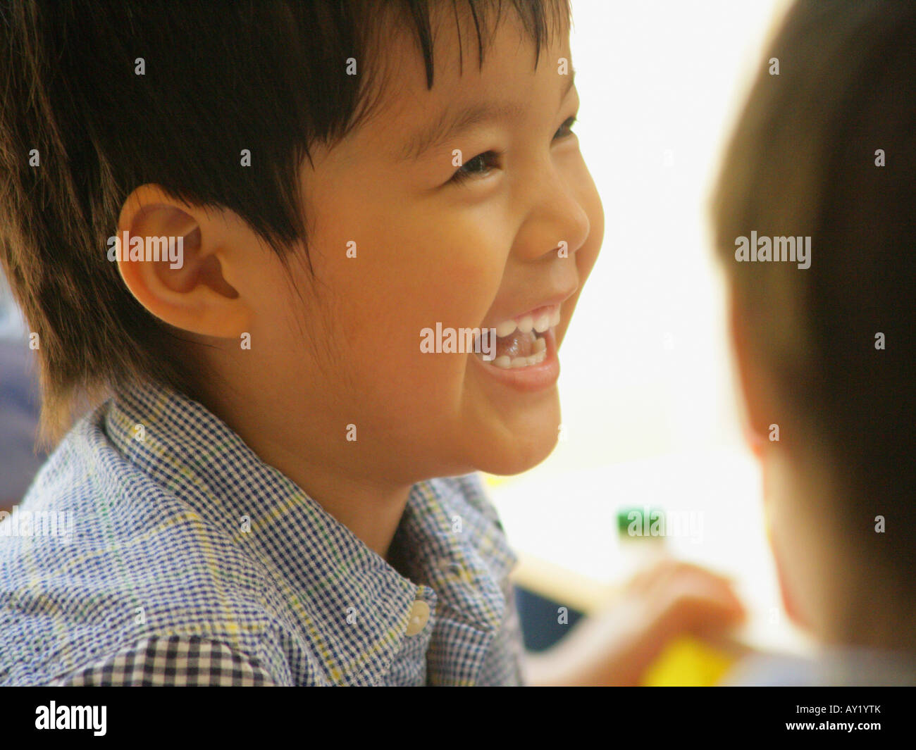 Side profile of a boy laughing Stock Photo - Alamy