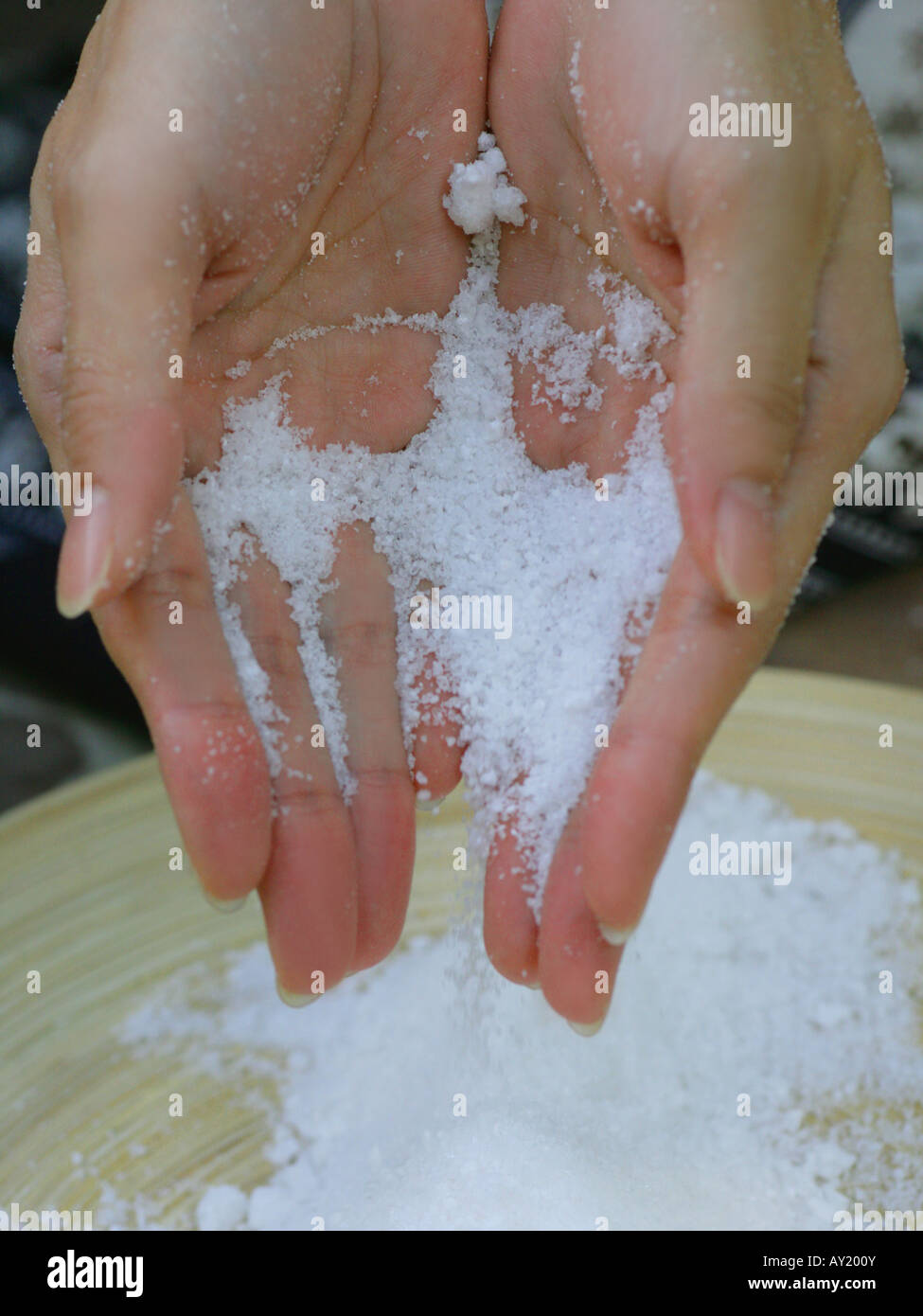 Woman pouring salt hands hi-res stock photography and images - Alamy