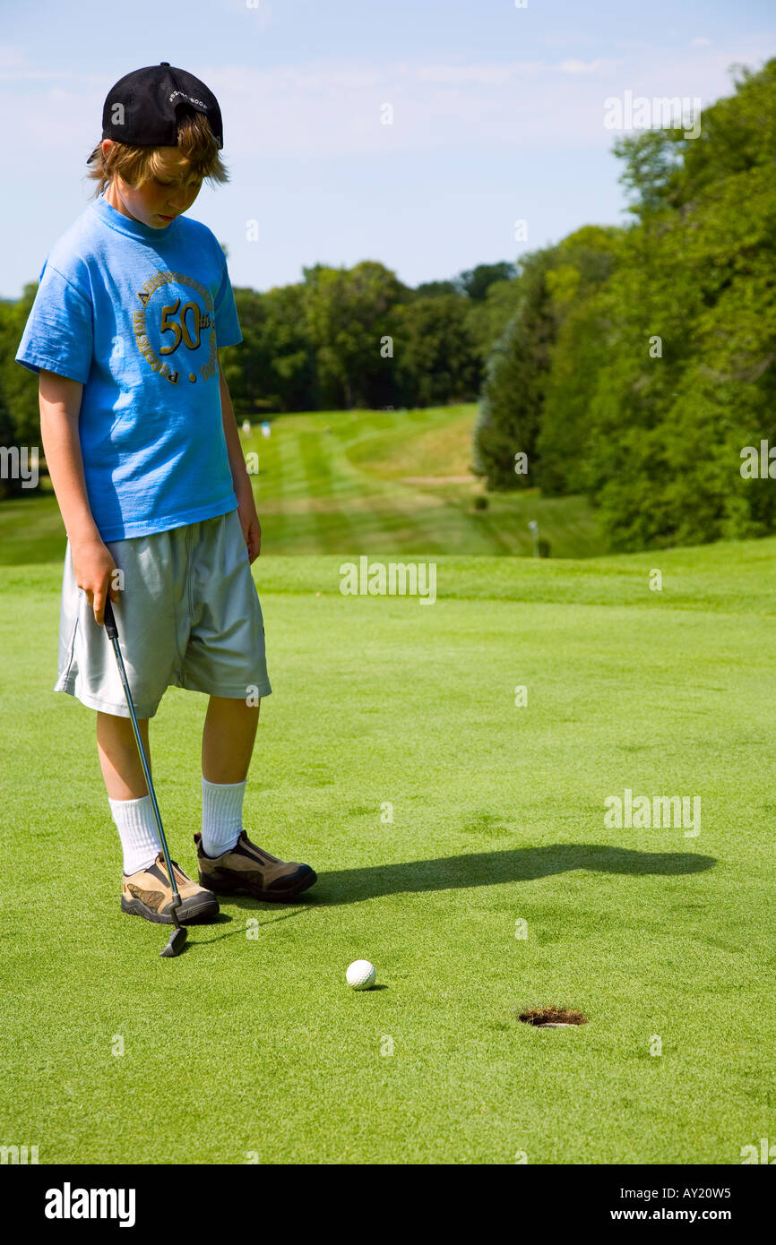 Young boy golfing Stock Photo - Alamy