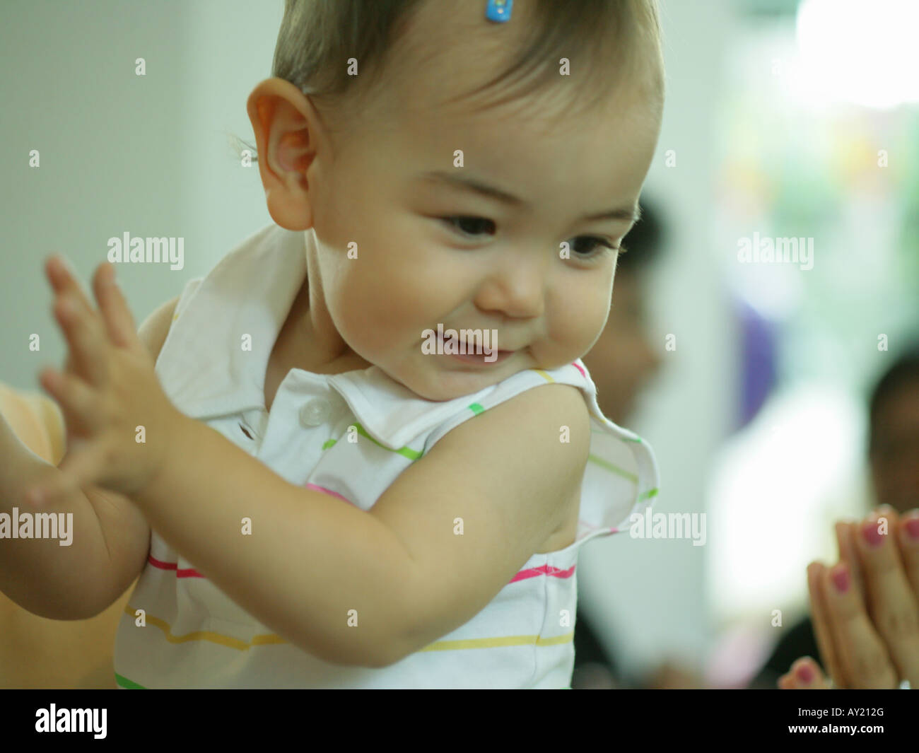 Close-up of a baby girl clapping Stock Photo - Alamy