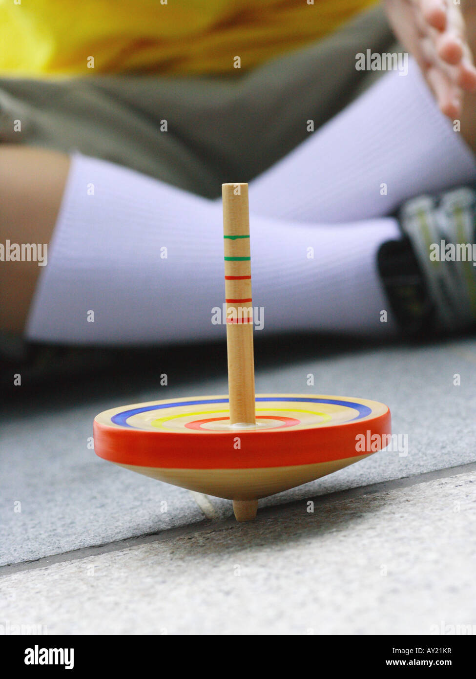 Mid section view of a boy playing with a top Stock Photo - Alamy