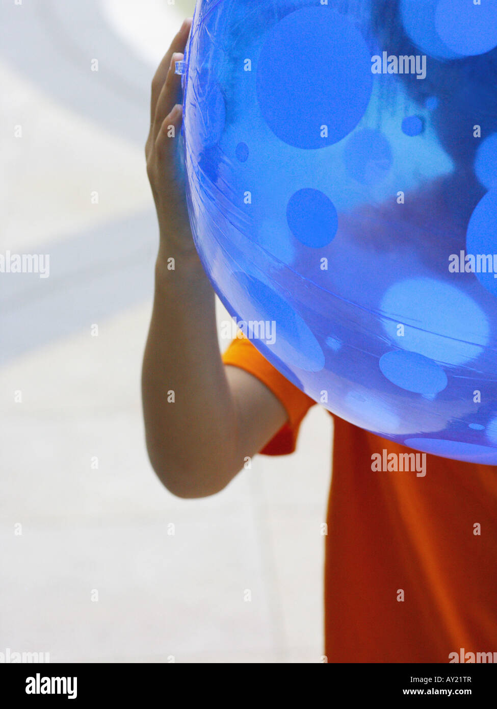 Close-up of a boy holding a ball in front of his face Stock Photo - Alamy