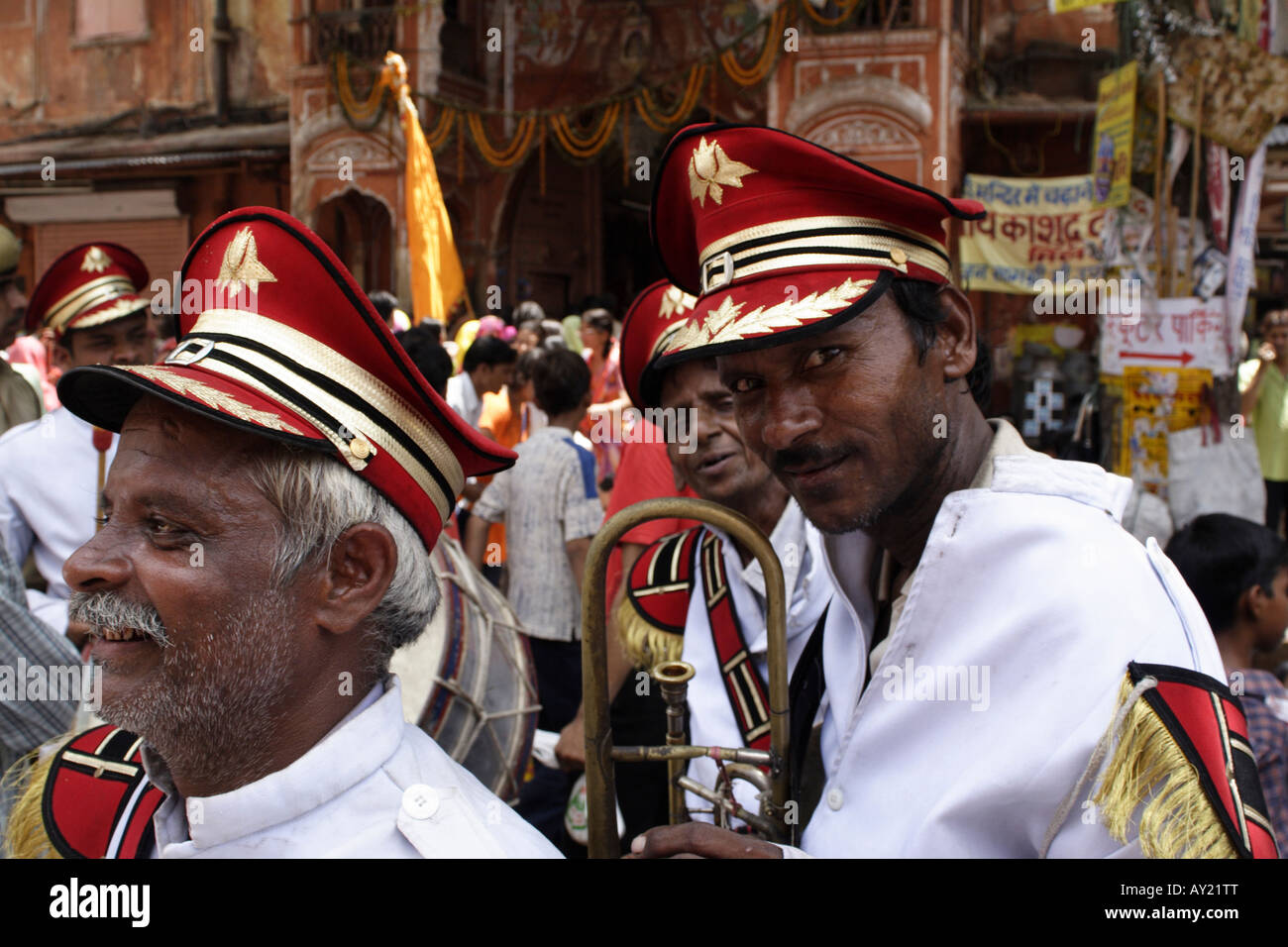 A uniformed wedding band jostles through a crowd in readiness to play ...